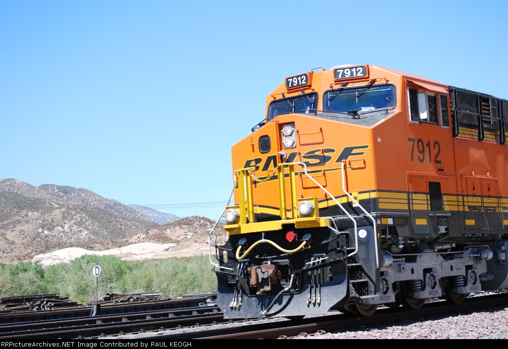 BNSF 7912 close up shot of the cab as she rolls down the Cajon Pass grade with Sullivan's Curve ...